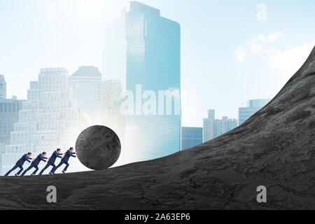 The team of people pushing stone uphill Stock Photo - Alamy