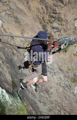 Zipline from the Victoria Falls Bridge over the Zambezi River, Zimbabwe ...