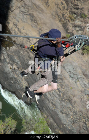 Zipline from the Victoria Falls Bridge over the Zambezi River, Zimbabwe ...
