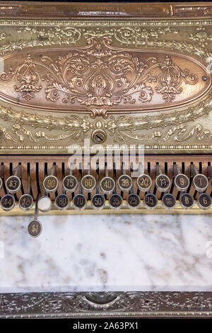 Gold and marble colored antique cash register with large gold keys and ...