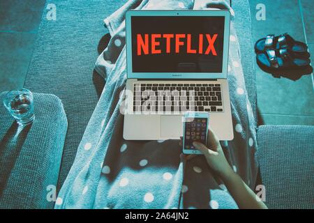 Smartphone and laptop with screen of Netflix logo Stock Photo - Alamy