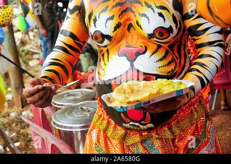 Men eating lunch before Pulikali Tiger Dance, Onam festival, Thrissur ...
