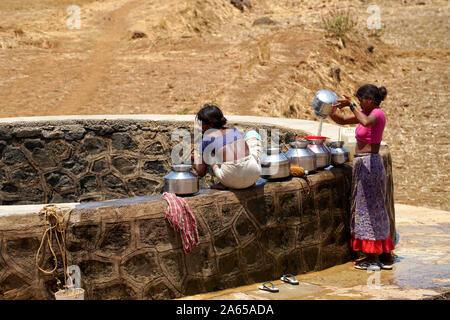 Women collecting water from well at village near Shahapur, Mumbai ...