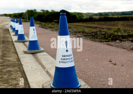 Motorway construction with a row of blue and white raod cones advising ...