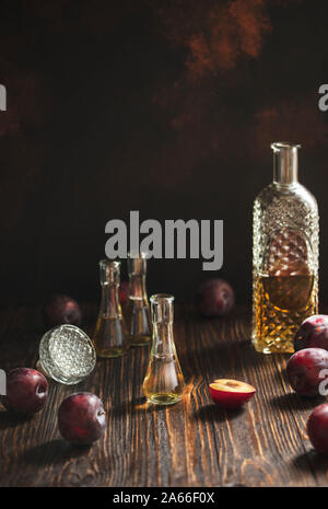 Glass bottle of Serbian traditional drink Rakia on the wooden table ...