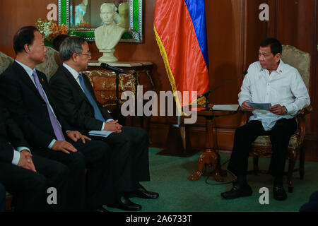 Philippine President Rodrigo R. Duterte smiles as he views two custom ...