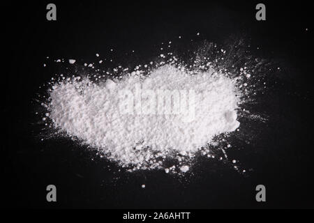 Ricin powder in a pile on black background Stock Photo - Alamy