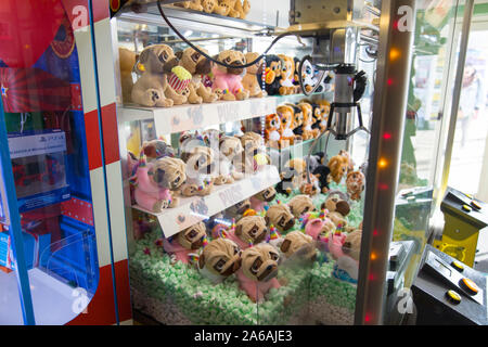 Toy grab claw machine at a funfair arcade Stock Photo - Alamy