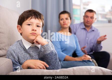 Portrait of upset boy scolded by parents at home Stock Photo - Alamy