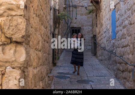 Living in Jerusalem. Everyday life in sacred city of Jerusalem. Mother ...