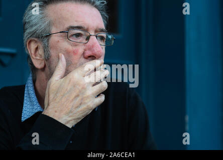 middle age man smoking cigarette on backjard, stylish tough guy ...