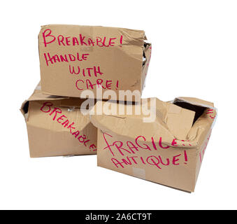 Horizontal shot of three stacked fragile cardboard boxes destroyed in shipping despite being ...
