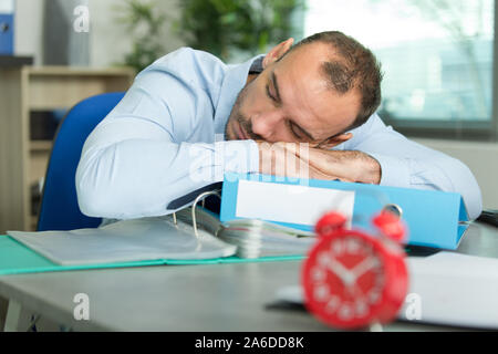 The sleepy businessman working in office Stock Photo - Alamy