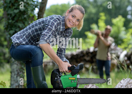 Woman with chainsaw Stock Photo - Alamy