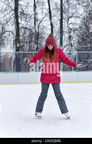 Beautiful girl having fun while skating at ice rink on Prague castle ...