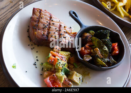 Healthy dinner, braised tuna fillet with grilled vegetables and salad ...