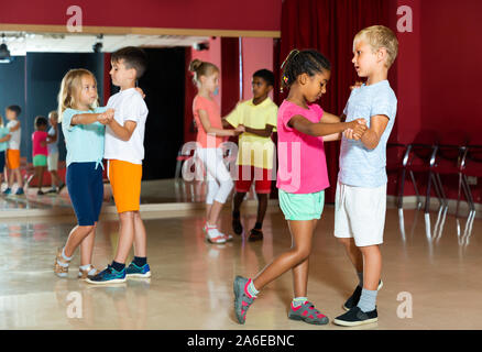 Group of kids dancing salsa dance in modern studio Stock Photo - Alamy