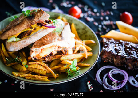 tasty ribs sandwich with french fries and fresh vegetables Stock Photo ...