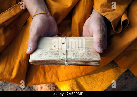 Buddhist monk holding a holy Buddhist parchment Stock Photo - Alamy