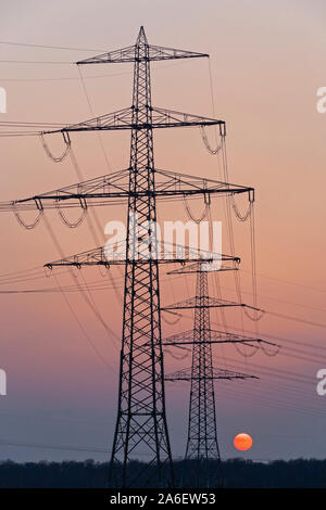 pylons in front of the setting sun Stock Photo - Alamy