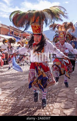 Pisac Peru man wearing a colorful chollo bakes empanadas in an ancient ...