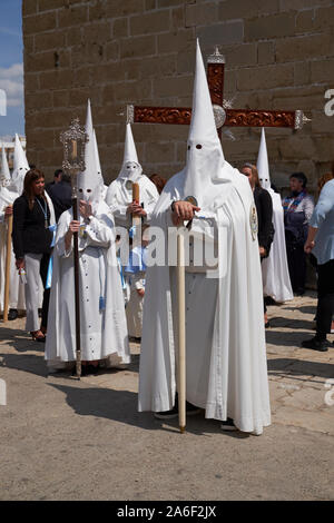 A religious brotherhood wearing penitential robes and conical hoods for ...