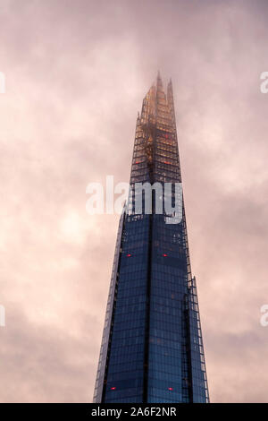 Misty sunset surrounding the top of the Shard, London England UK Stock ...