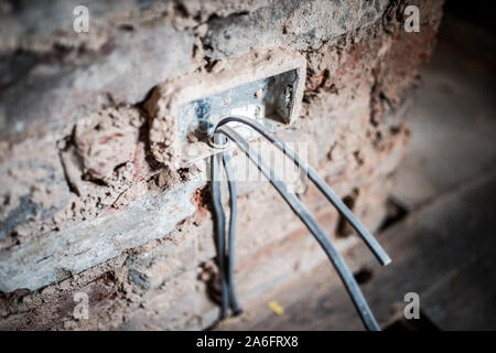 An electrician wires in the 1st fix of an electrical installation ...
