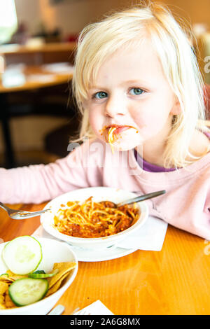 Little blonde girl having lunch Stock Photo - Alamy
