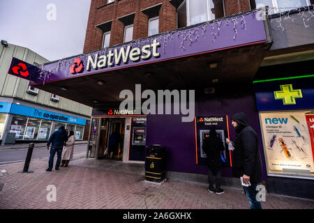 Customers entering and leaving the Natwest Bank and using the cash ...