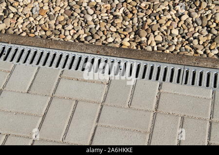 a sewage gutter on a paved place Stock Photo - Alamy