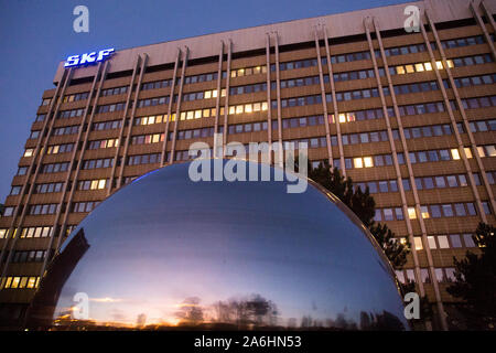 A large, reflective silver ball imitating a bearing in front of the SKF ...