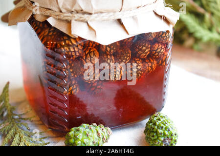 Jar of tasty pine cone jam on white background Stock Photo - Alamy