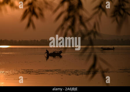 Kashmiri boatmen row their boats during a spring Morning in the ...