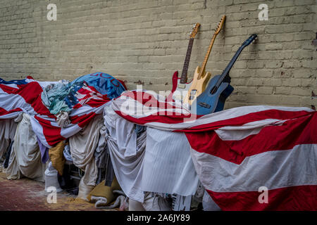 Homeless people carts belongings covered with a giant American flag ...