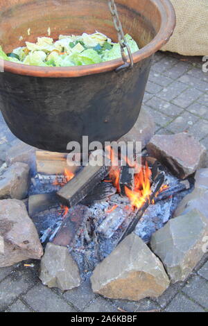 old copper cauldron over the fire made of burning woods and boiling ...