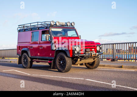 Red Land Rover Defender 110 4WD car navigating a Green Lane track ...