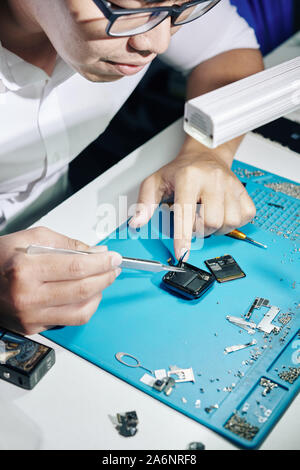The computer technician repairing broken computer in workshop Stock ...