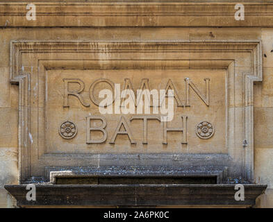 Stone carved sign at the Roman Baths with the Bath Abbey in the ...