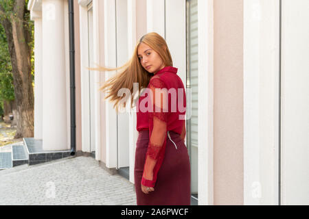 Portrait of a beautiful girl turned around and looked into the frame ...