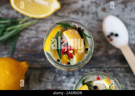 Fermented lemons in jars of salt, chili pepper and rosemary. Probiotics ...