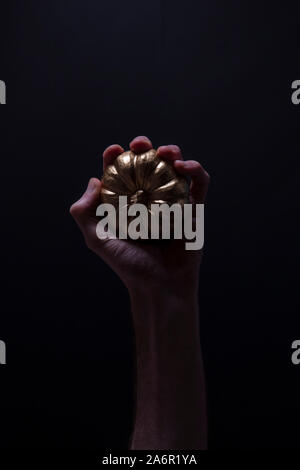 Hand holding Jack-o-Lantern with black background Stock Photo - Alamy