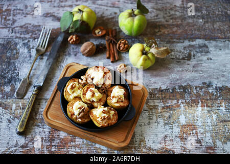 Baked quince with cinnamon and cream cheese. Healthy autumn food. Keto ...