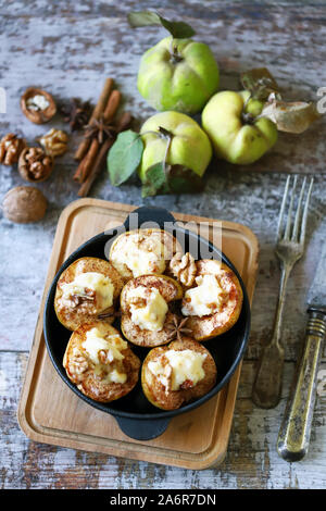 Baked quince with cinnamon and cream cheese. Healthy autumn food. Keto ...