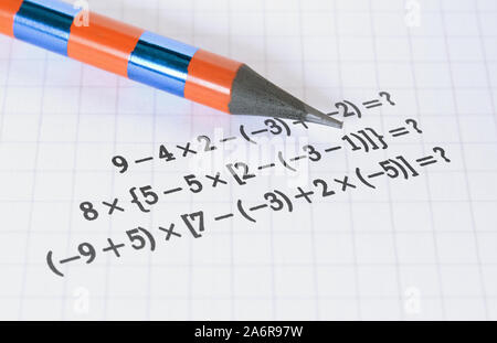 Example of the basic math operations and a pencil on bright background ...