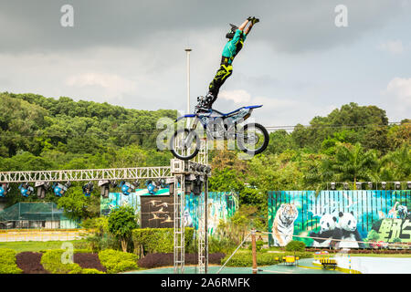 A professional motorcycle rider giving a free style motorcross ...