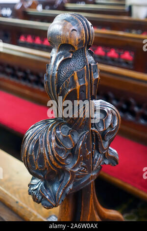 Ornate decorative carved oak wood church pews with bibles, All Saints ...