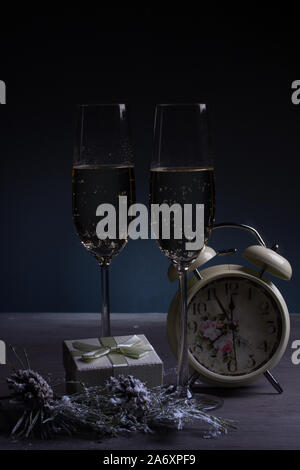 Alarm clock, Christmas decor and glasses on black background with space ...