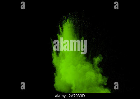 Green powder explosion on black background.Green dust particles splash ...