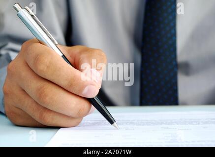 the hand of the man does entries in official papers Stock Photo - Alamy